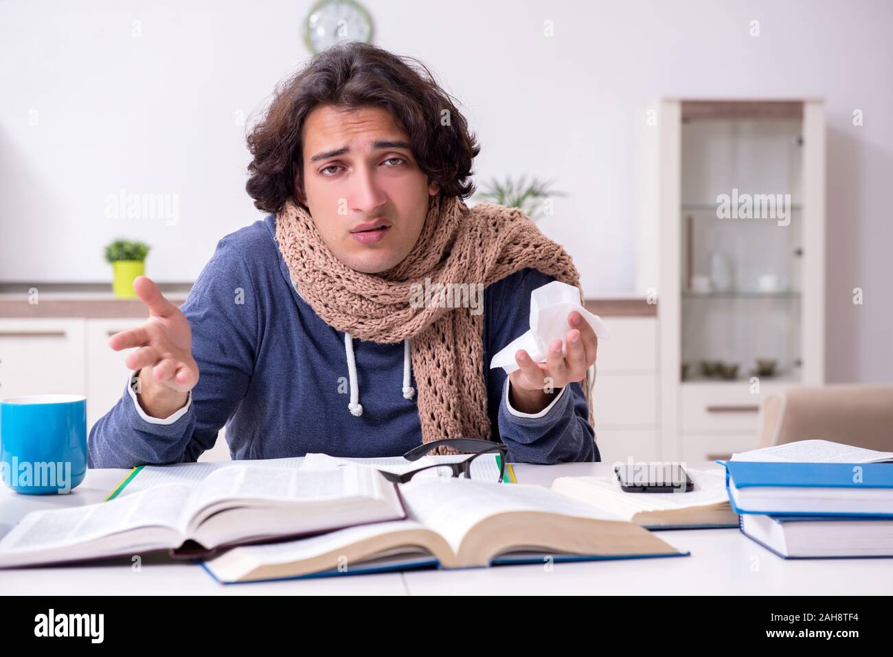 The sick male student suffering at home Stock Photo - Alamy