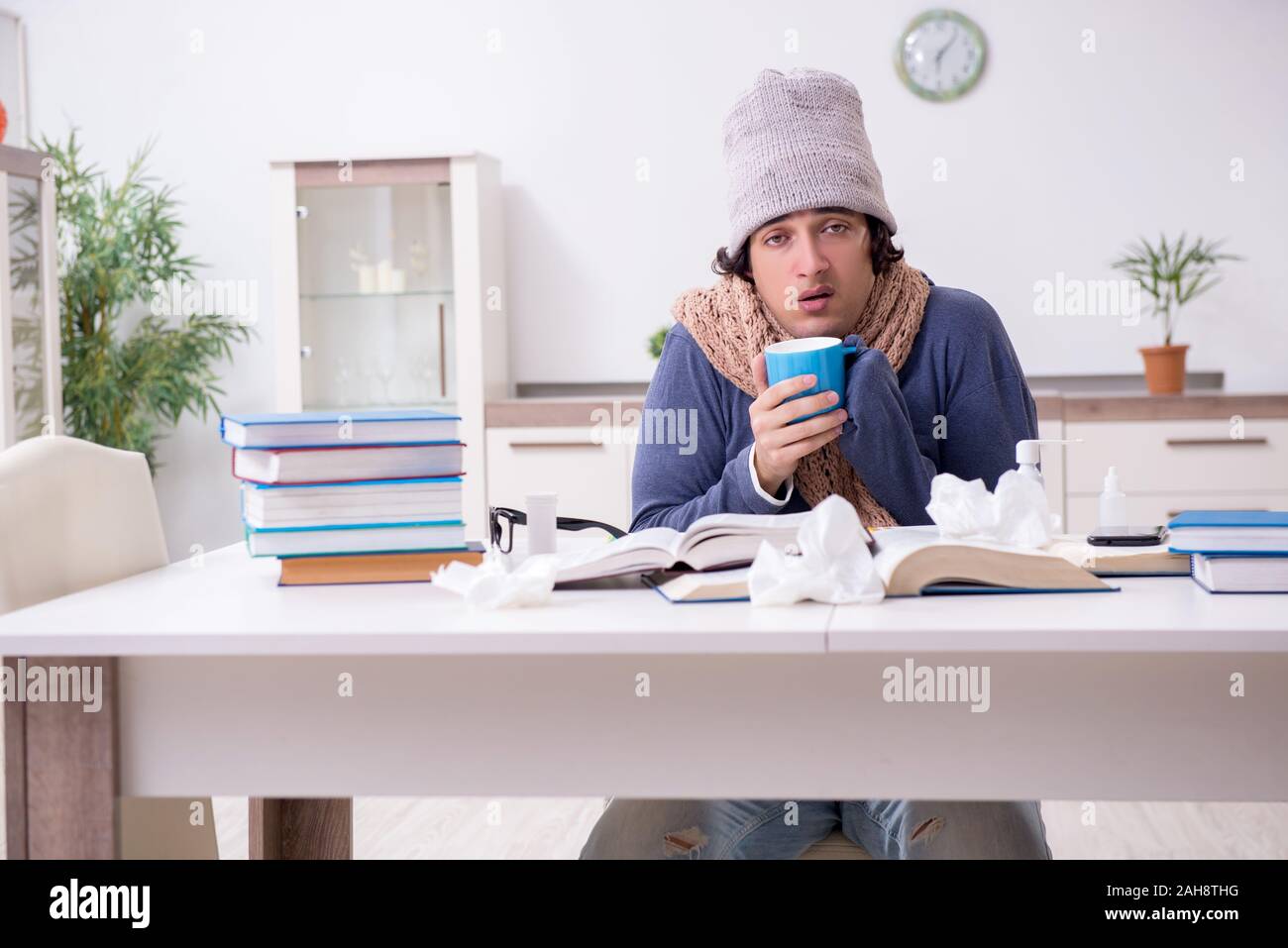 The sick male student suffering at home Stock Photo - Alamy