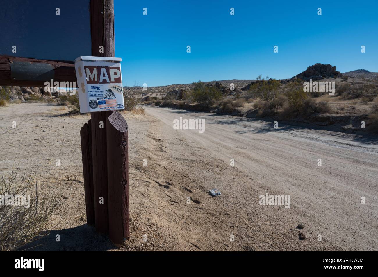 Map container holding maps for road in desert Stock Photo - Alamy