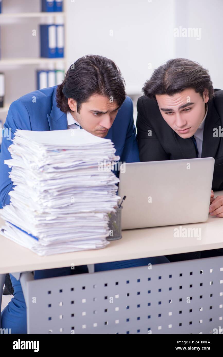 The two male colleagues unhappy with excessive work Stock Photo - Alamy