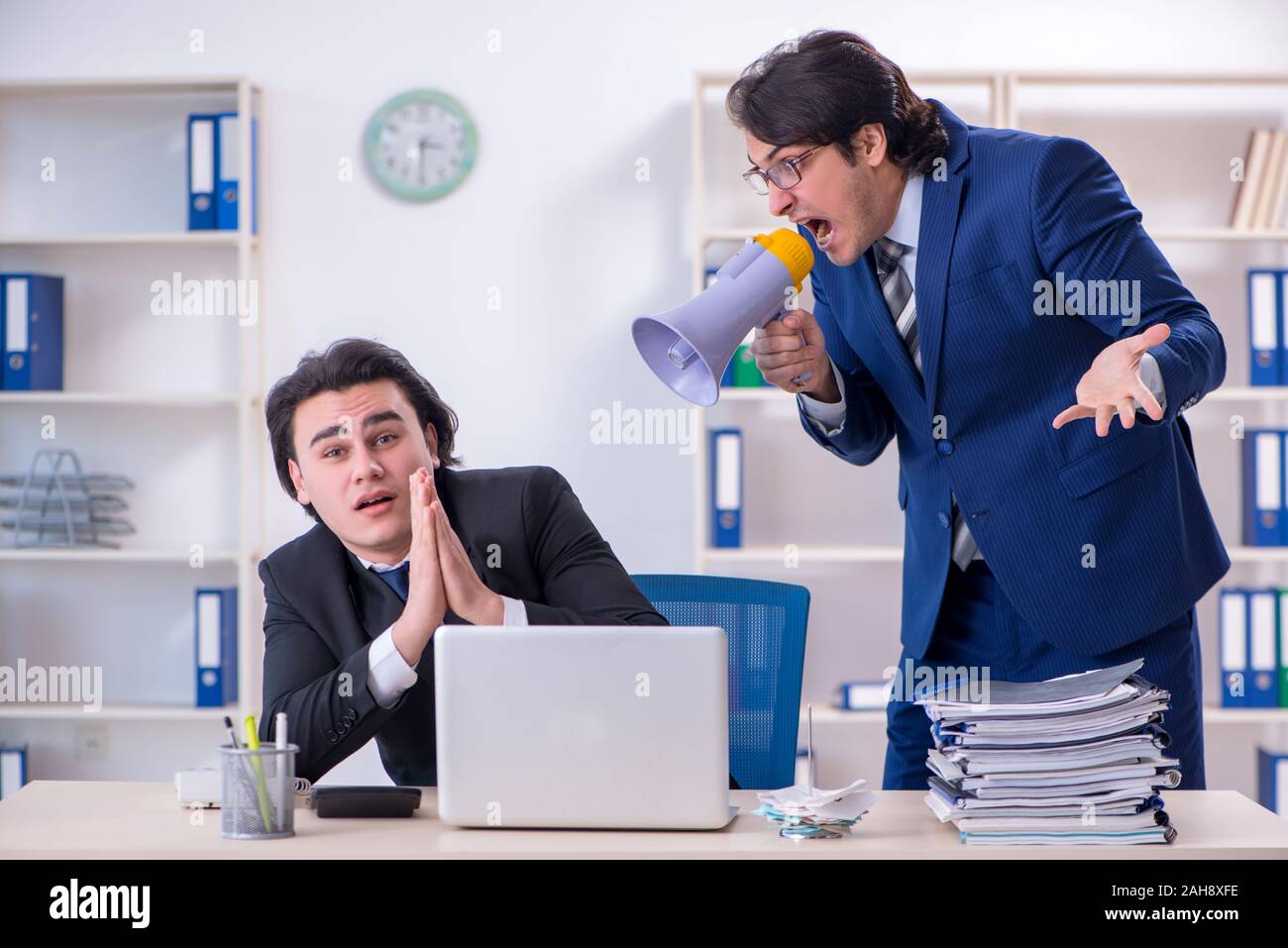 The boss and his male assistant working in the office Stock Photo - Alamy