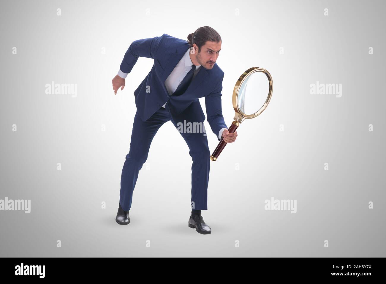 The businessman with giant magnifying glass Stock Photo - Alamy