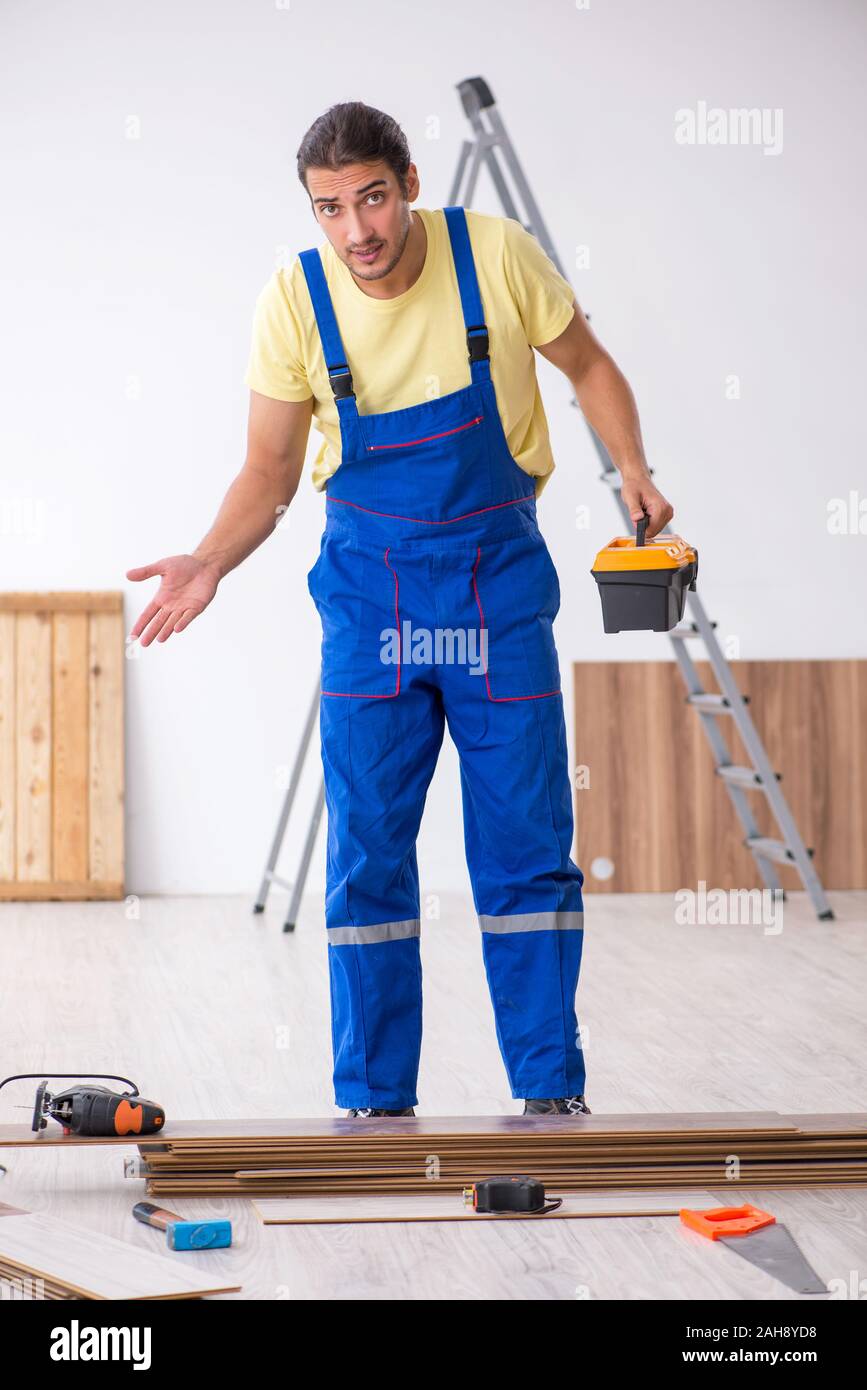 The young male contractor working indoors Stock Photo - Alamy