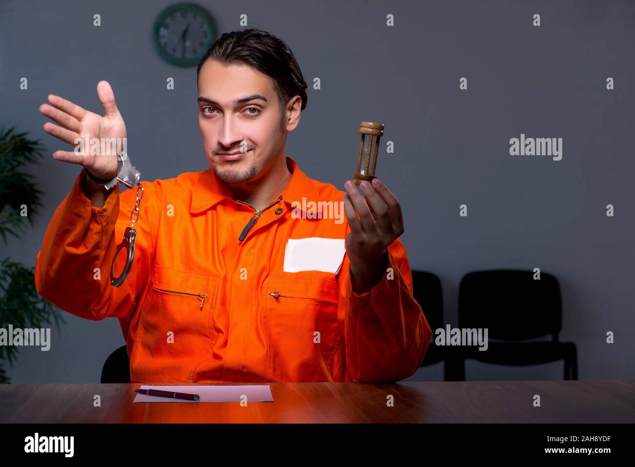 The young convict man sitting in dark room Stock Photo - Alamy