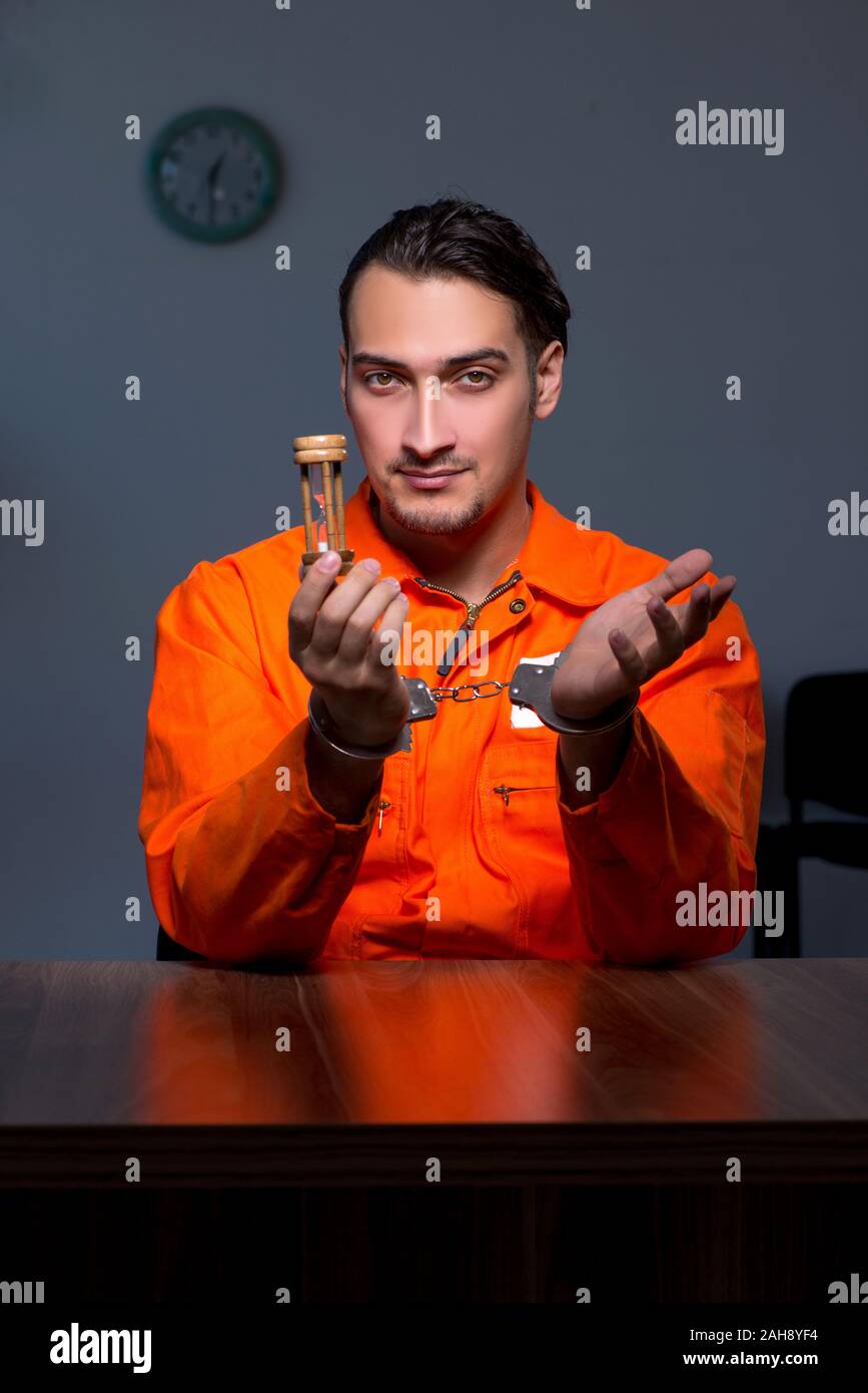 The young convict man sitting in dark room Stock Photo - Alamy