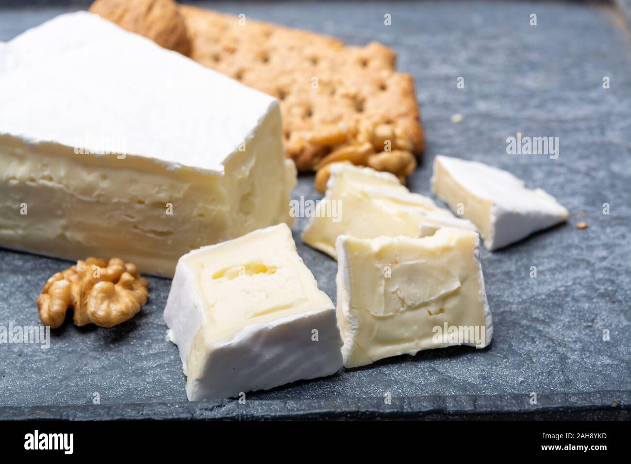 Cheese collection, piece of French brie cheese with white mold close up ...