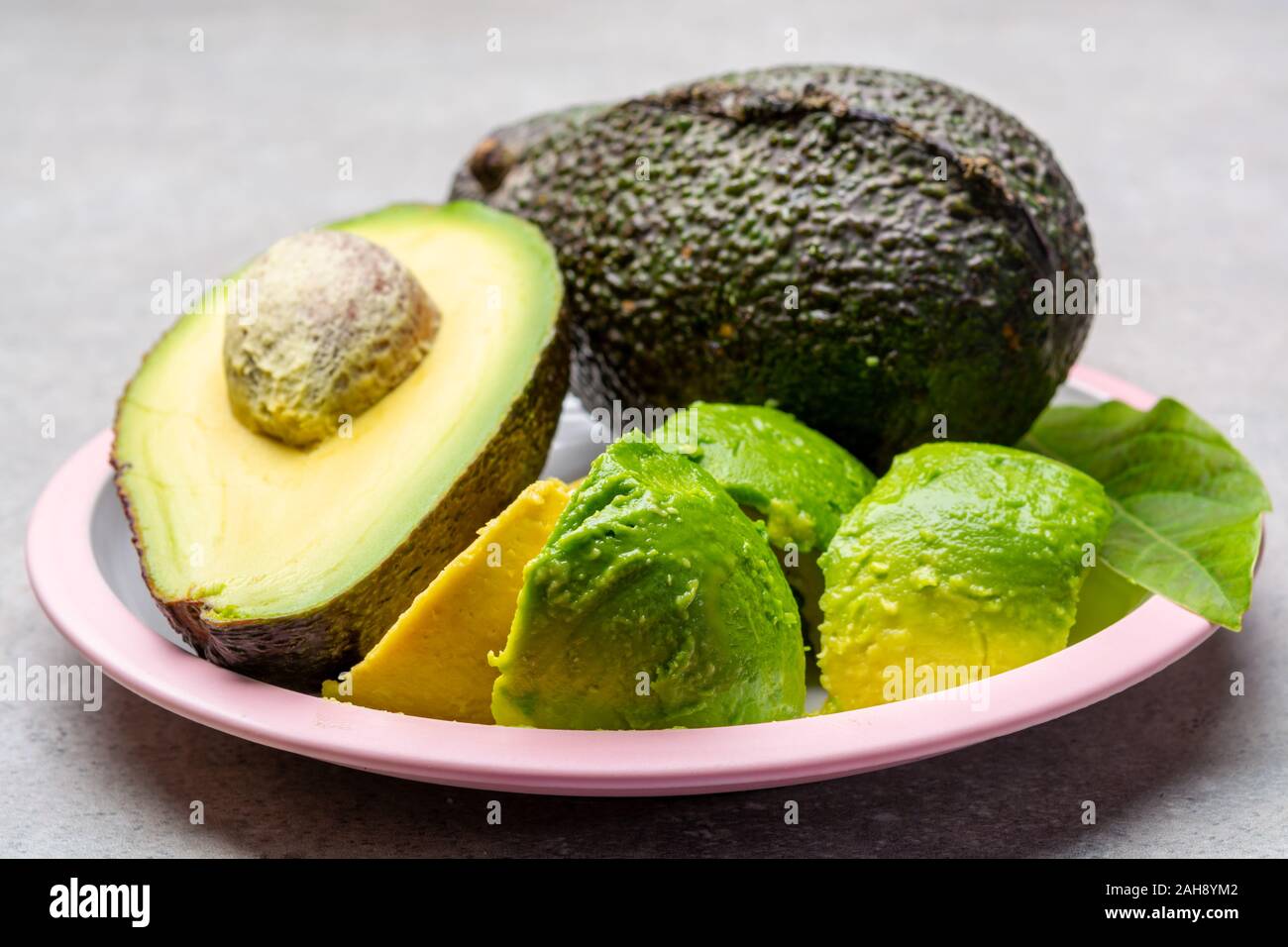 Eating of fresh ripe green organic hass avocado tropical fruit Stock ...