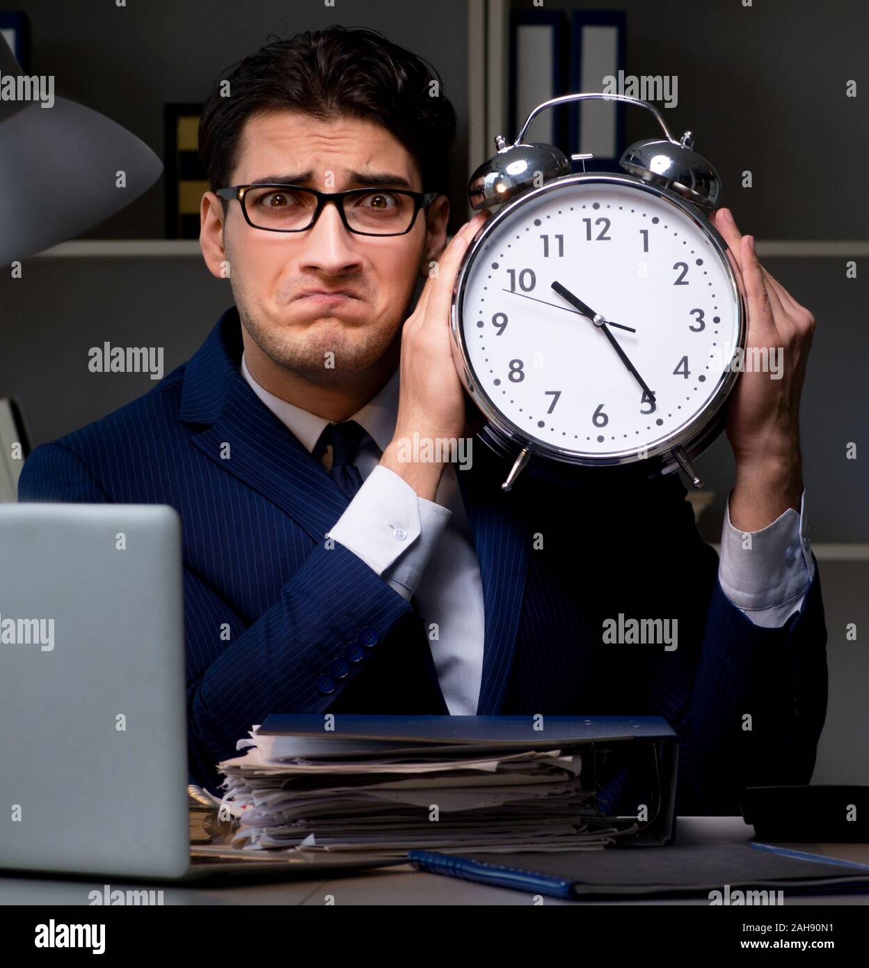 Employee staying late to finish work on auditing Stock Photo - Alamy