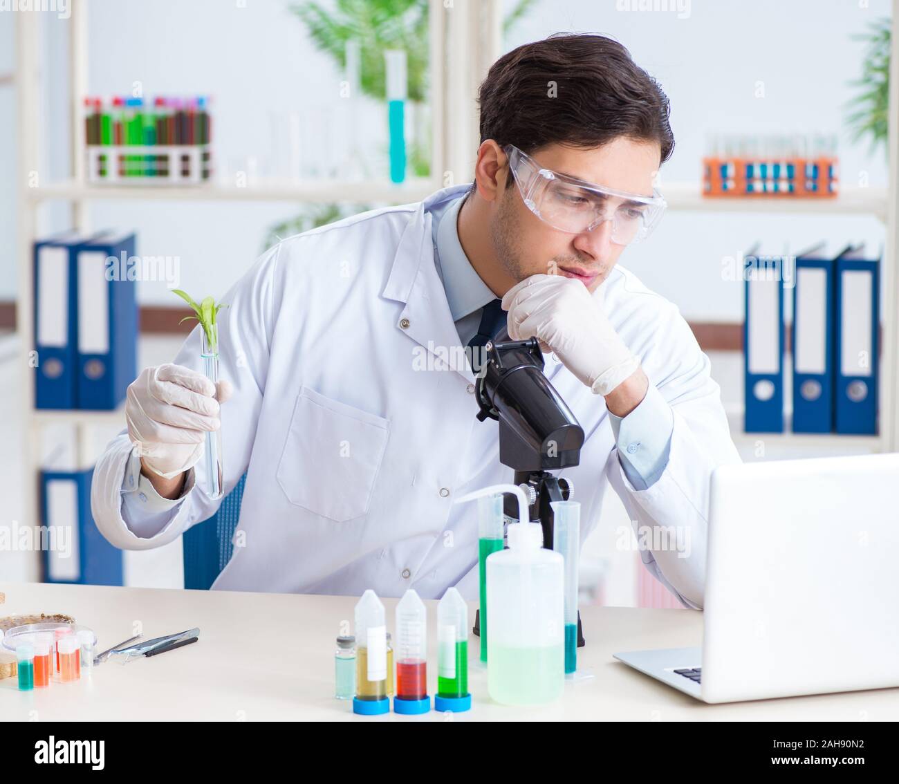 The male biochemist working in the lab on plants Stock Photo - Alamy