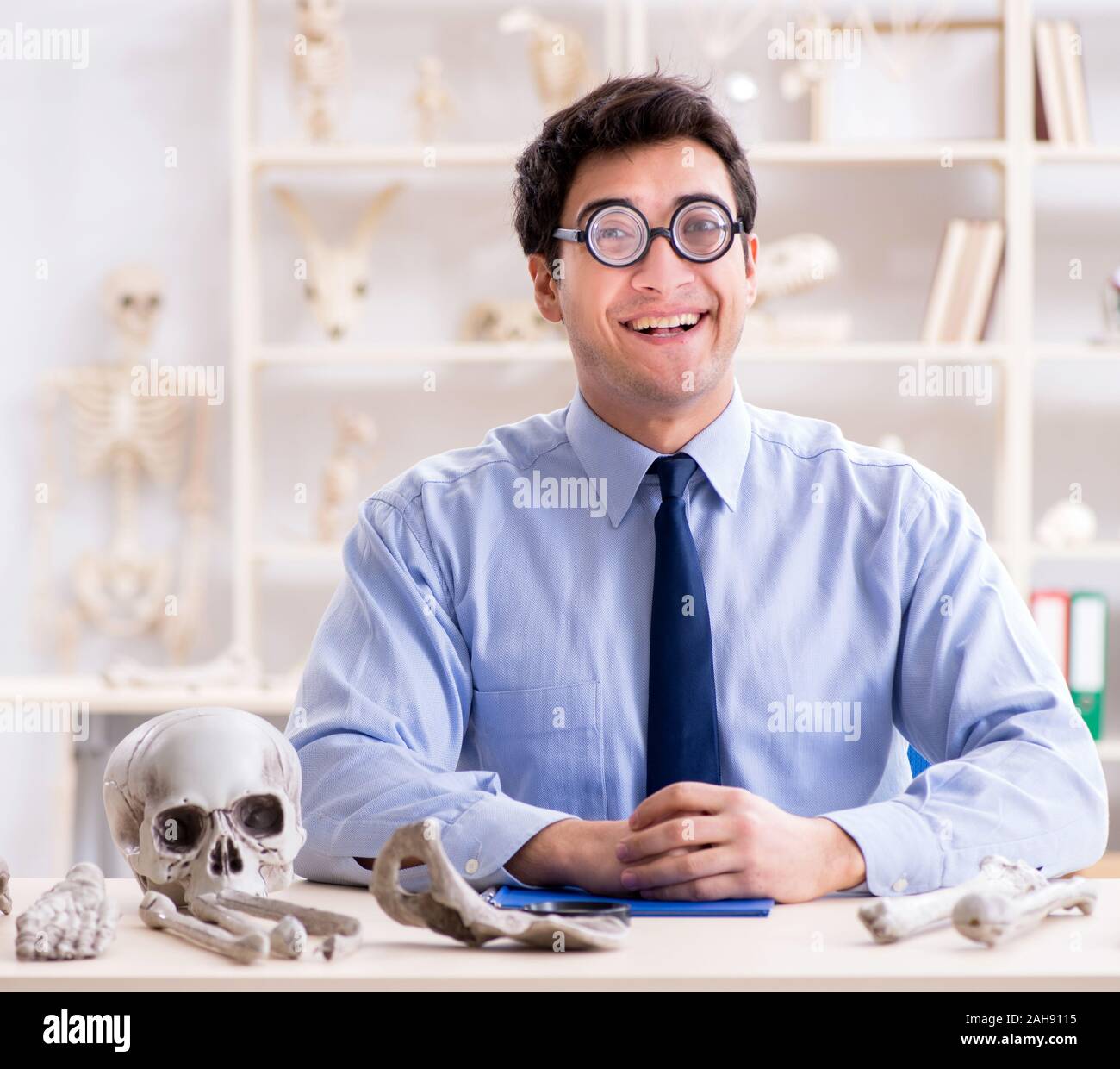 The funny crazy professor studying human skeleton Stock Photo - Alamy