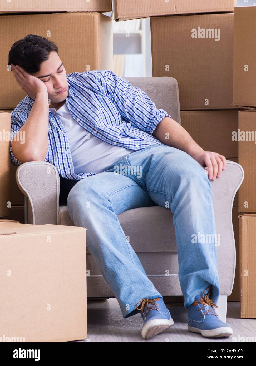The young man moving in to new house with boxes Stock Photo - Alamy