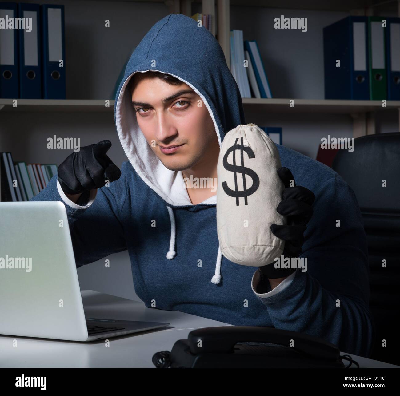 Young hacker hacking into computer at night Stock Photo - Alamy