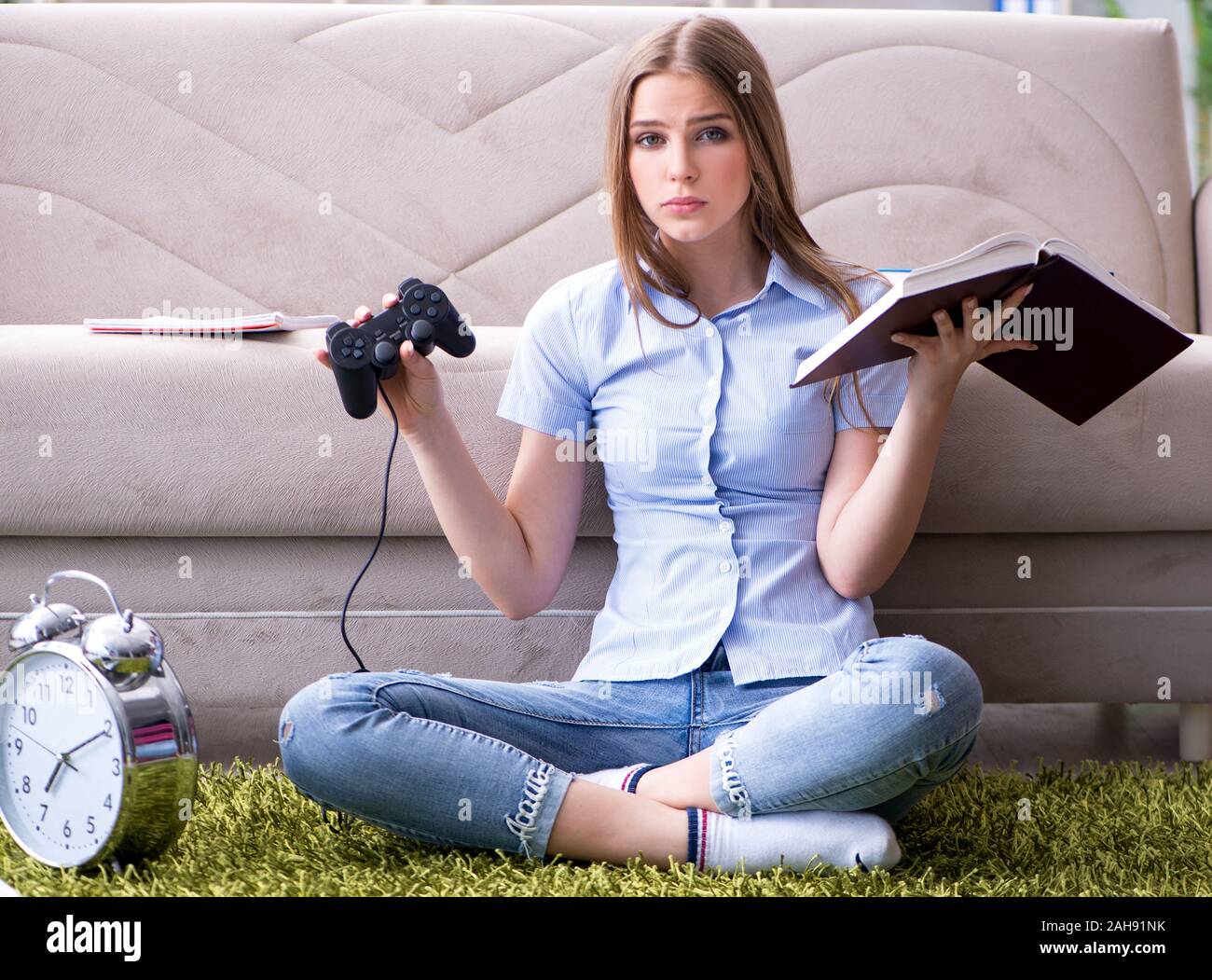 The female student being distracted from exam preparation Stock Photo ...