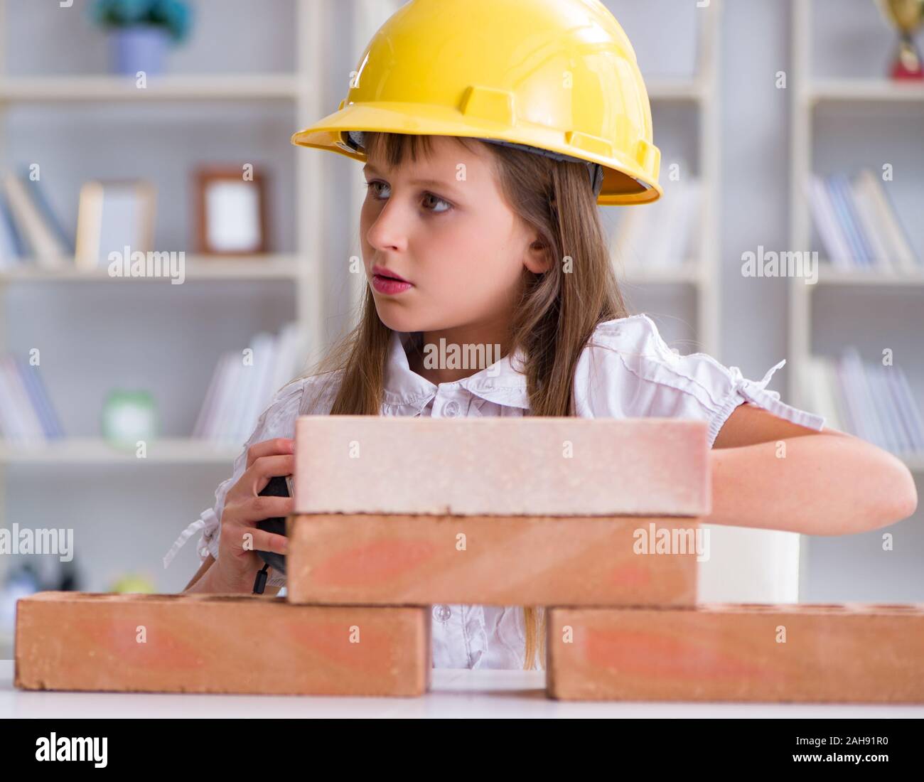 The young girl building with construction bricks Stock Photo - Alamy