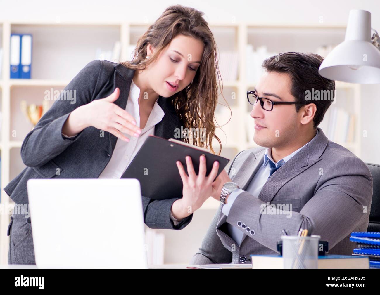 The unhappy boss having a chat with his secretary Stock Photo - Alamy