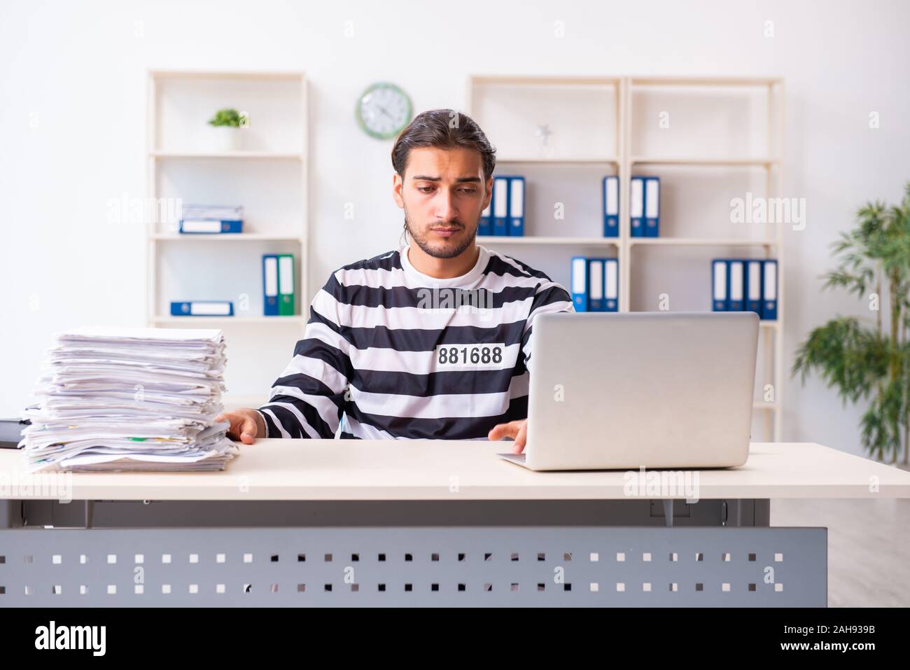 The young employee feeling like prisoner at work Stock Photo - Alamy