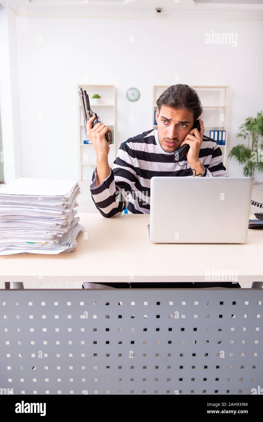 The young employee feeling like prisoner at work Stock Photo - Alamy