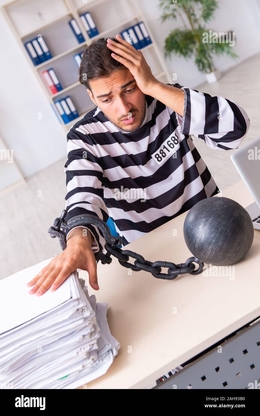 The young employee feeling like prisoner at work Stock Photo - Alamy