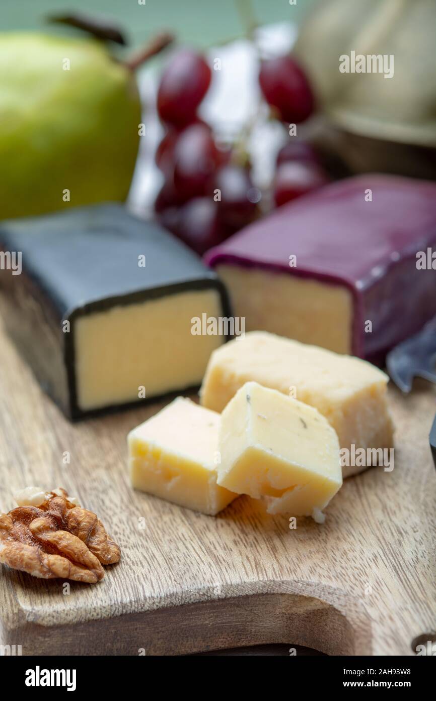 Mini black and dark red waxed cheddar cheeses made from West Country ...