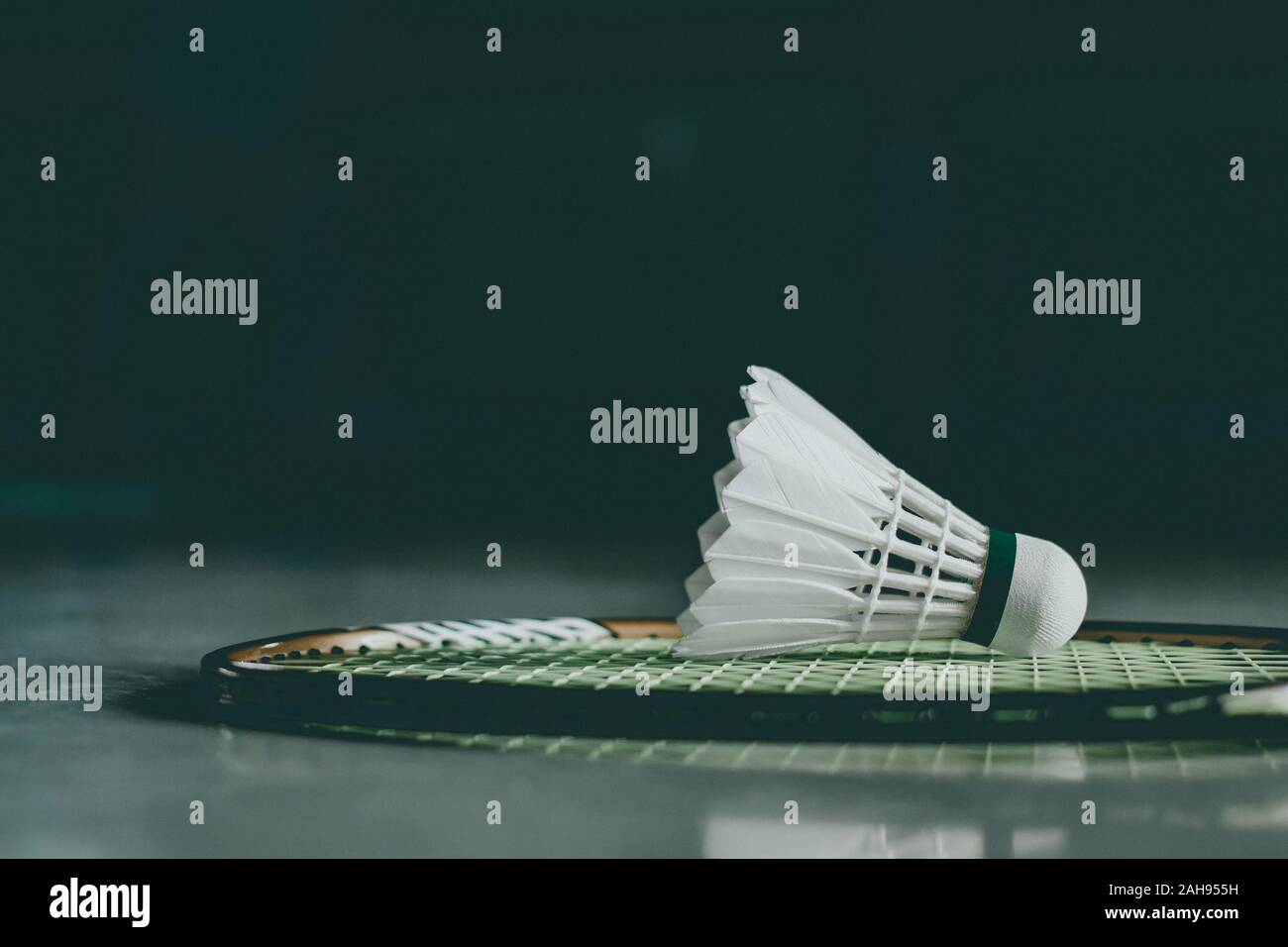 Shuttlecocks and badminton racket on court background Stock Photo - Alamy