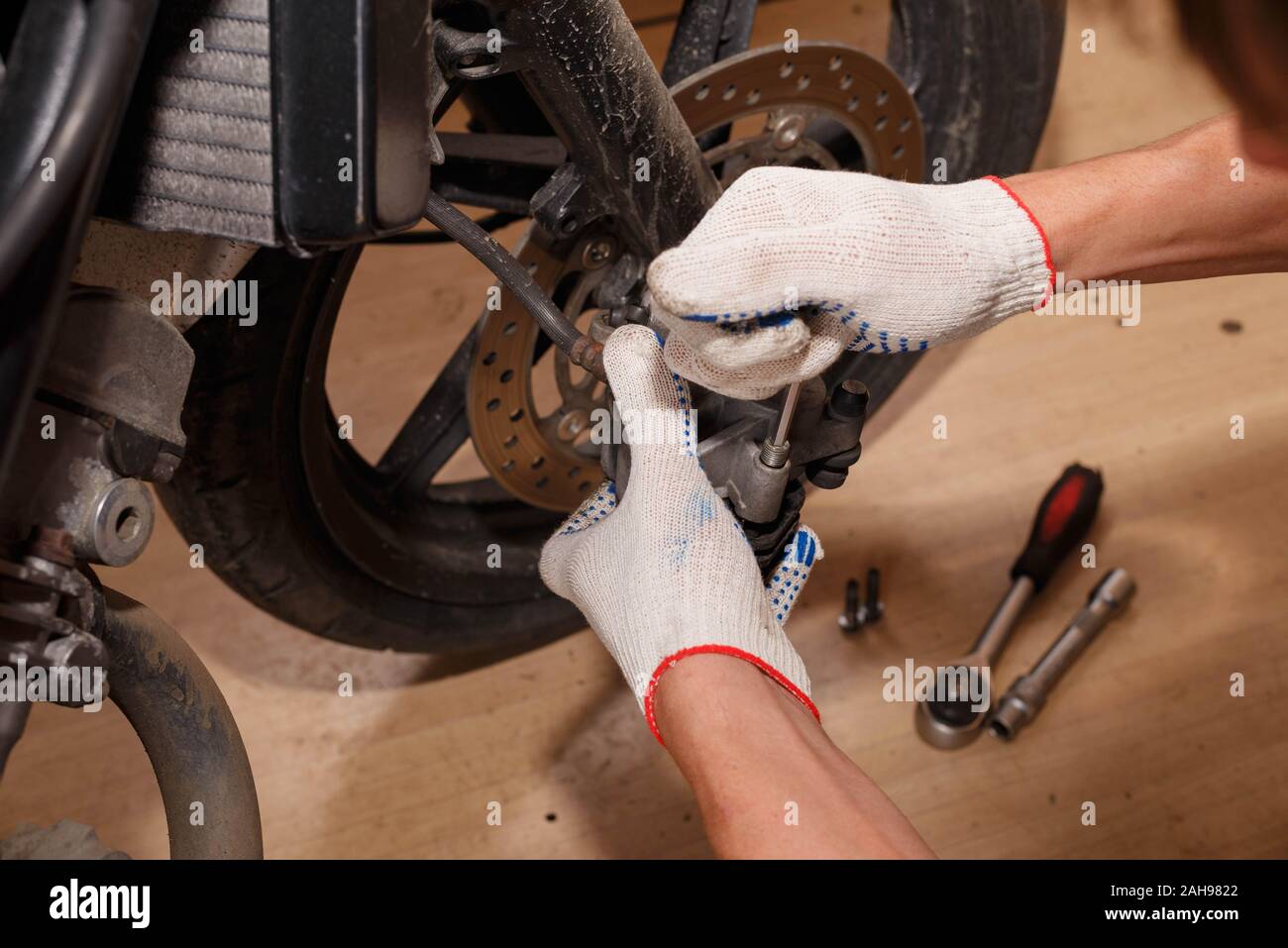 The process of replacing brake pads on a motorcycle. Maintenance ...