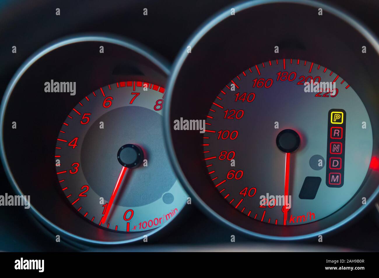 The dashboard of the car is glowing blue with red arrows at night with ...