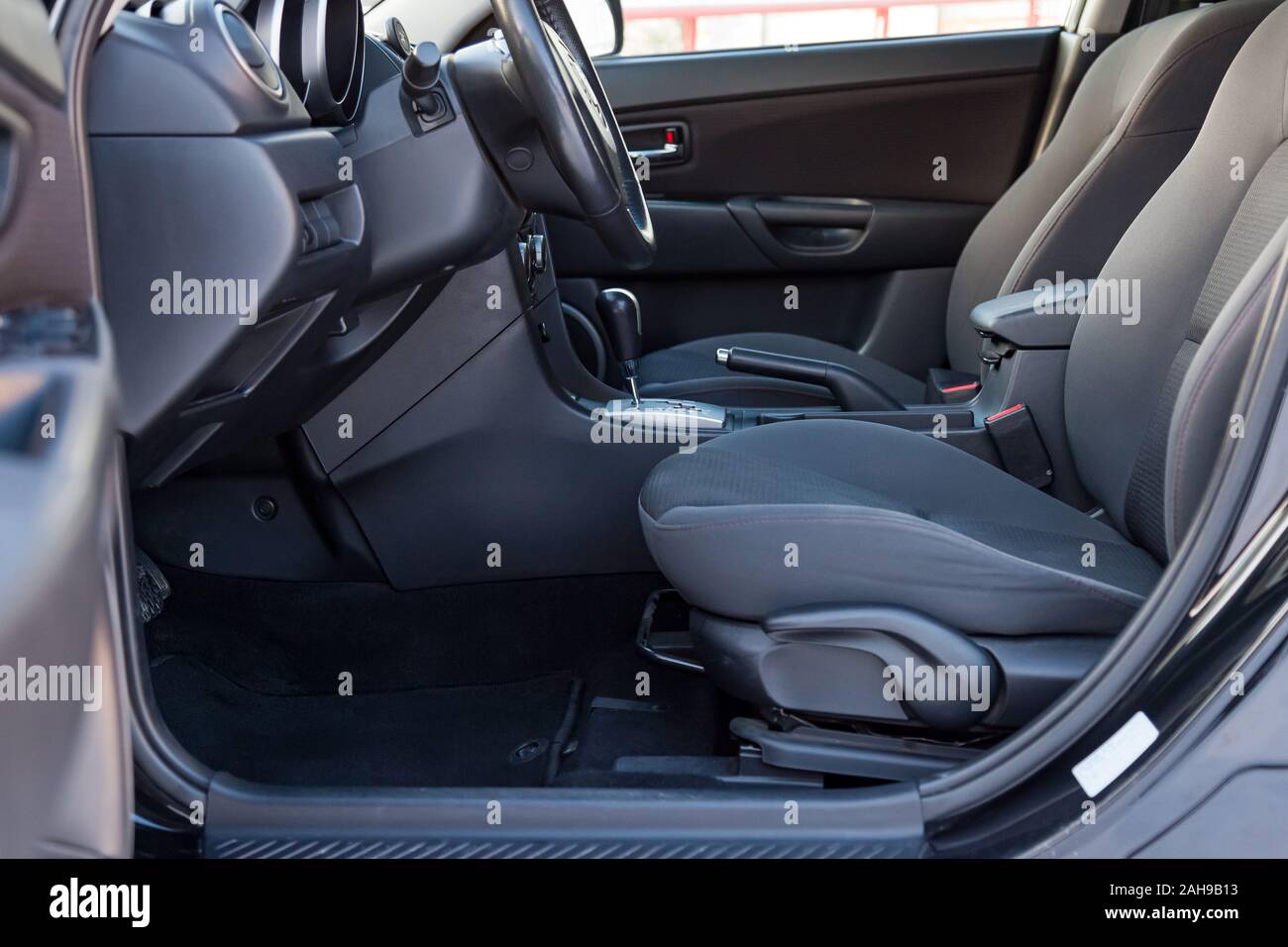 Comfortable front seats inside the car: the driver and passenger, tied ...