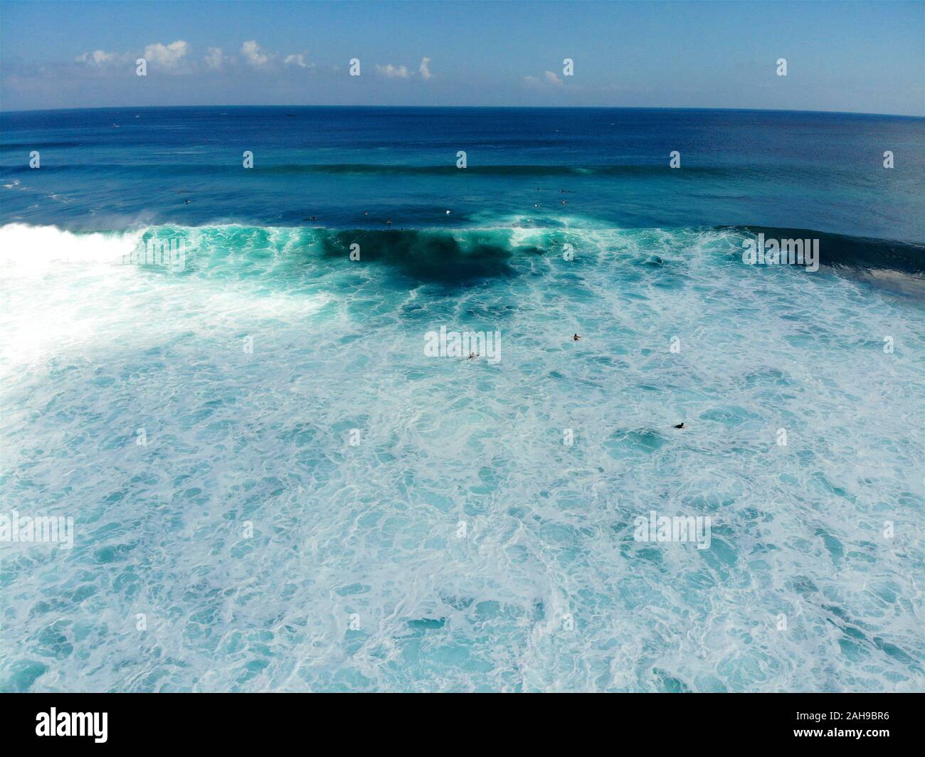 Aerial view of surfers on their board catching the waves,, big waves ...