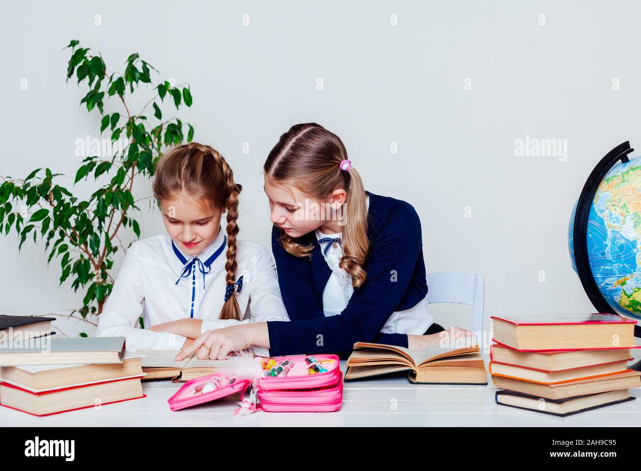 two girls in the school geography lesson study knowledge in the ...
