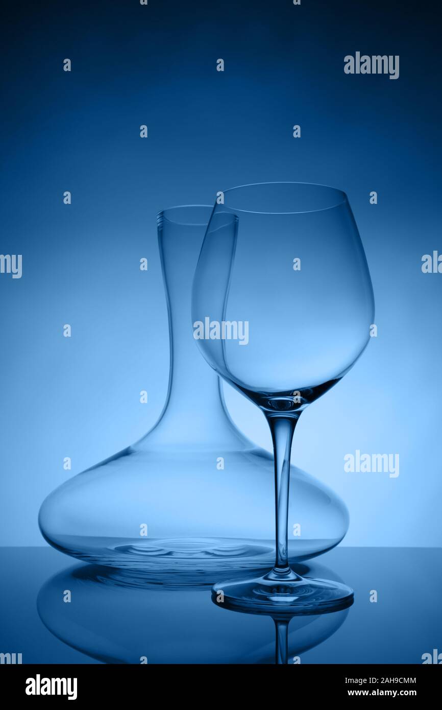 Glassware selection with wine glass and decanter on classic blue ...