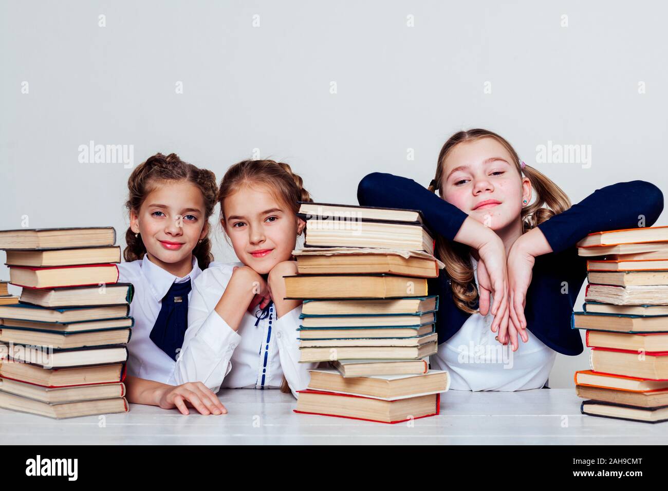 three girls at school in the classroom for books of knowledge Stock ...