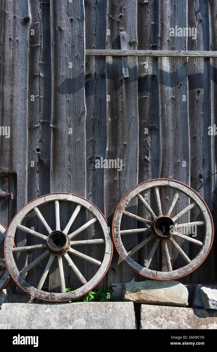 Two old wagon wheels in front of a barn hi-res stock photography and ...