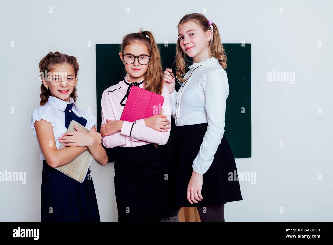 three girls in glasses at the Blackboard in a class lesson Stock Photo ...