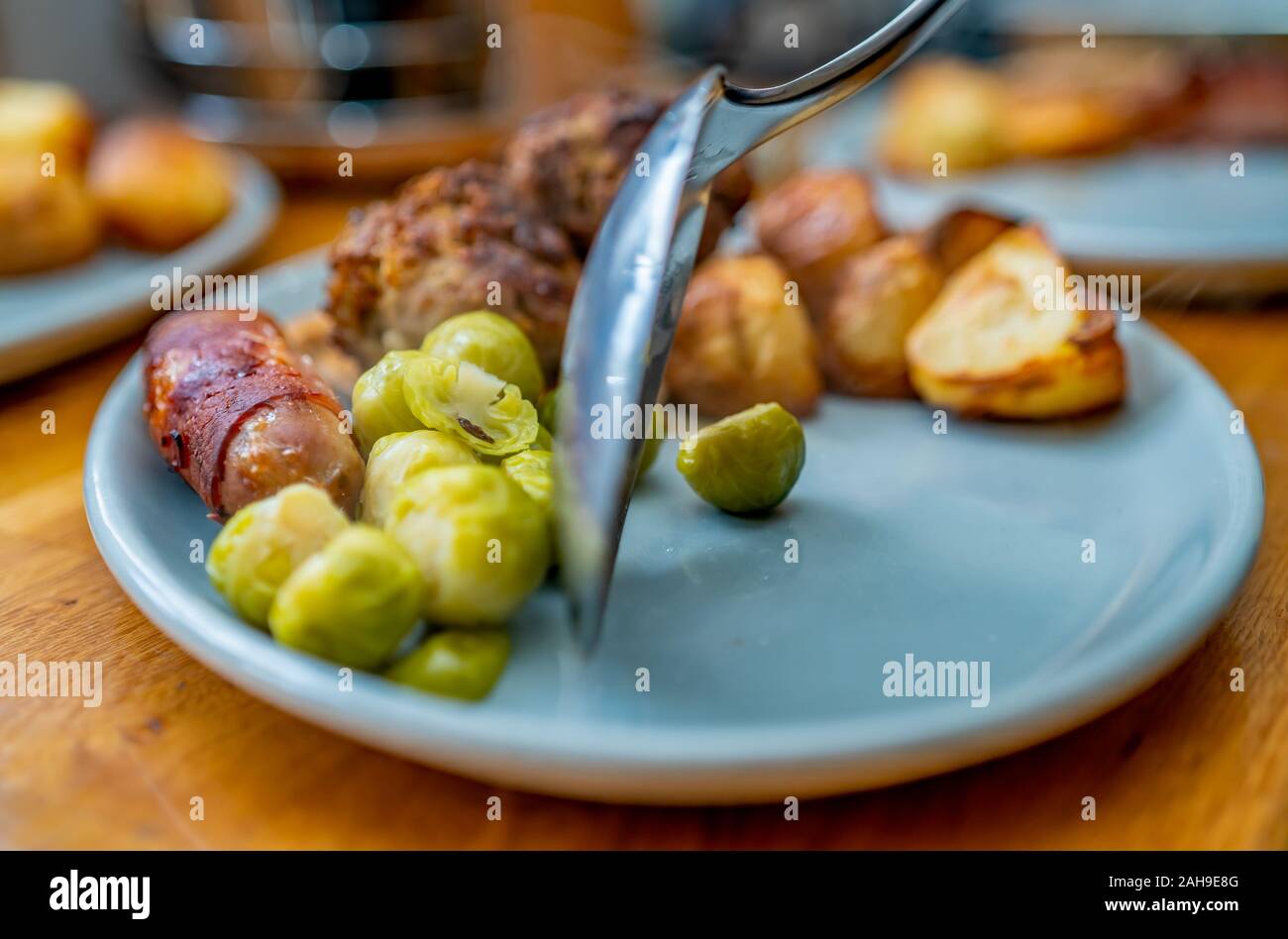 Selective focus and close up of an unidentifiable chef dishing up a ...