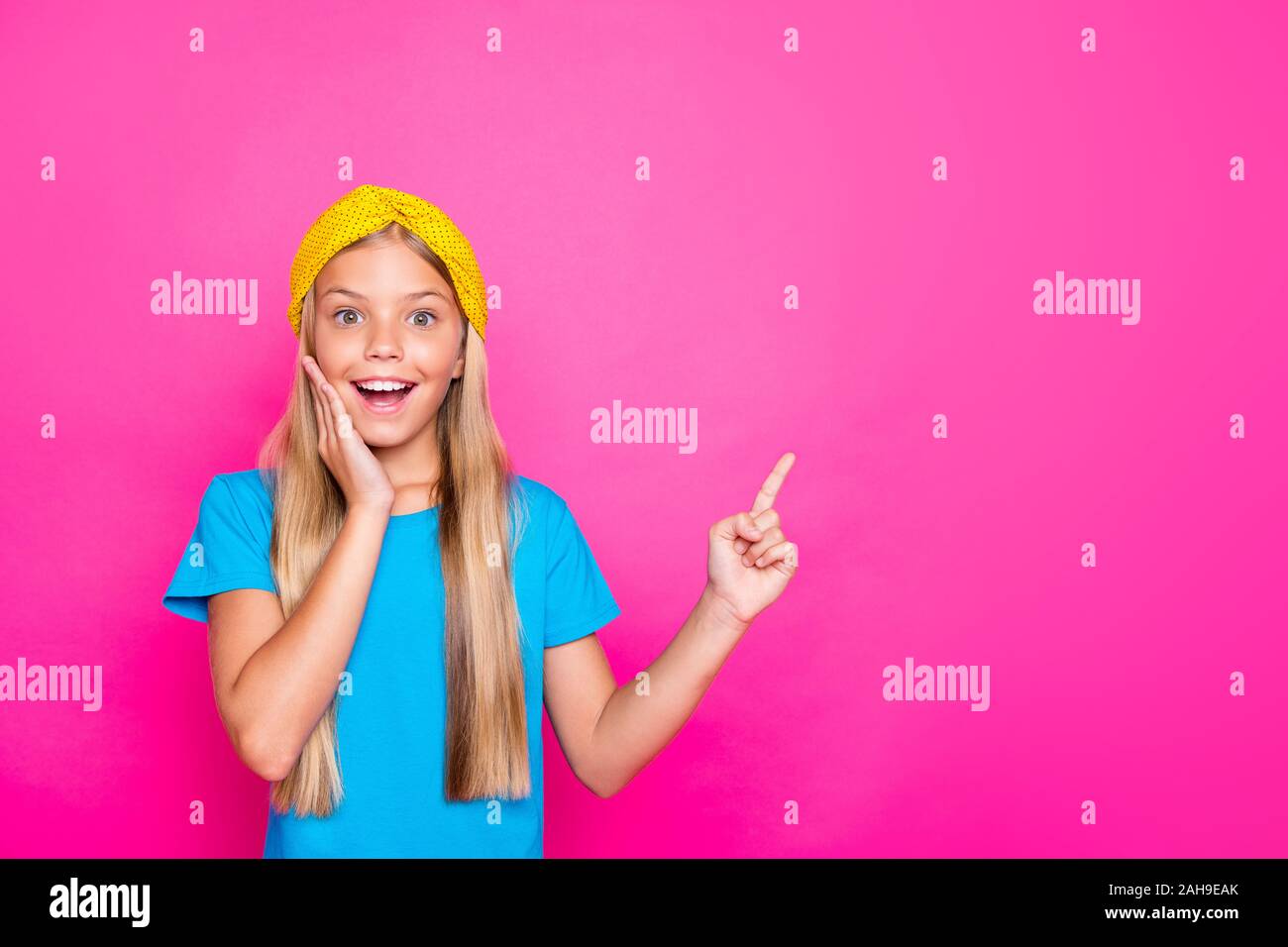 Portrait of amazed crazy funny funky child point index finger copy ...