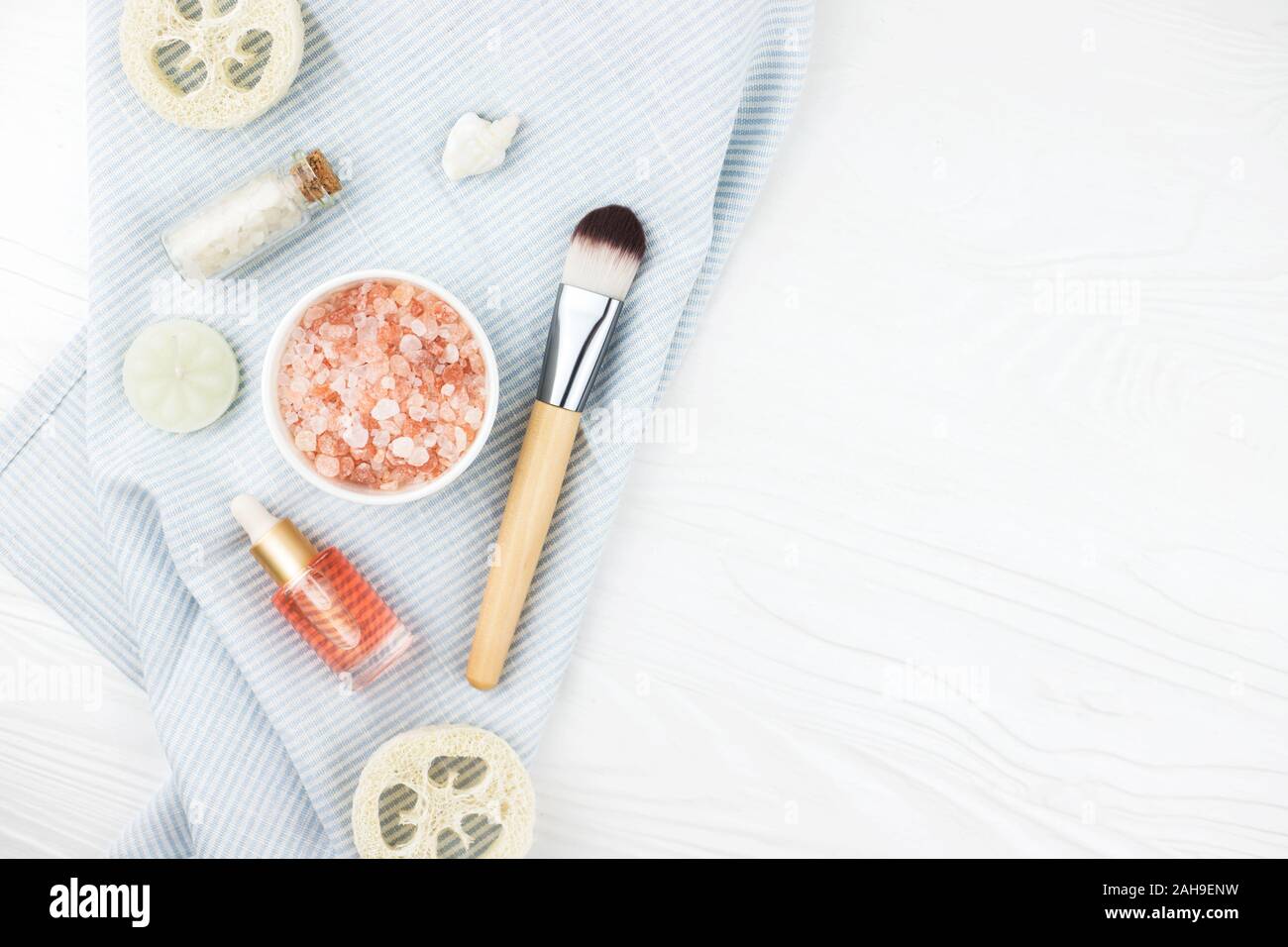 Homemade spa cosmetic set with salt and oil on white wooden background ...
