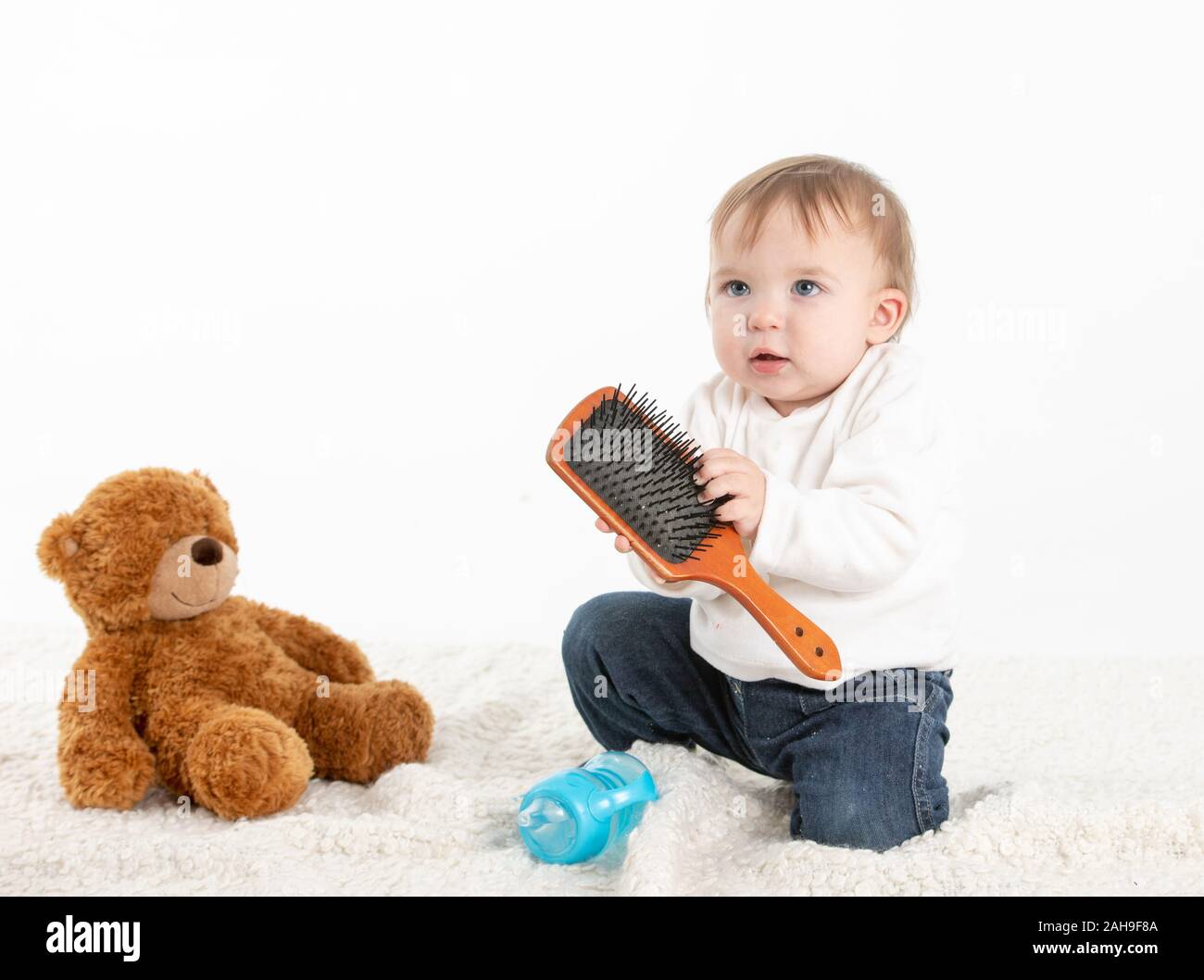 Stock studio photo with a white background of a baby playing with a ...