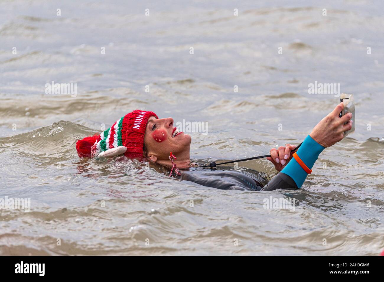 Female swimmer in woollen elf hat at the RNLI Southend Boxing Day Dip ...