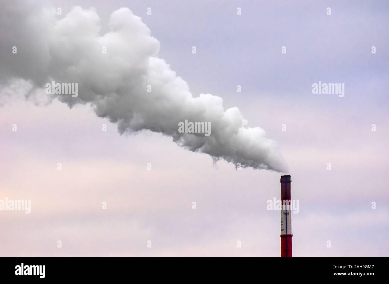 Smoking Tall Industrial Chimney on a Windy Overcast Day Stock Photo - Alamy