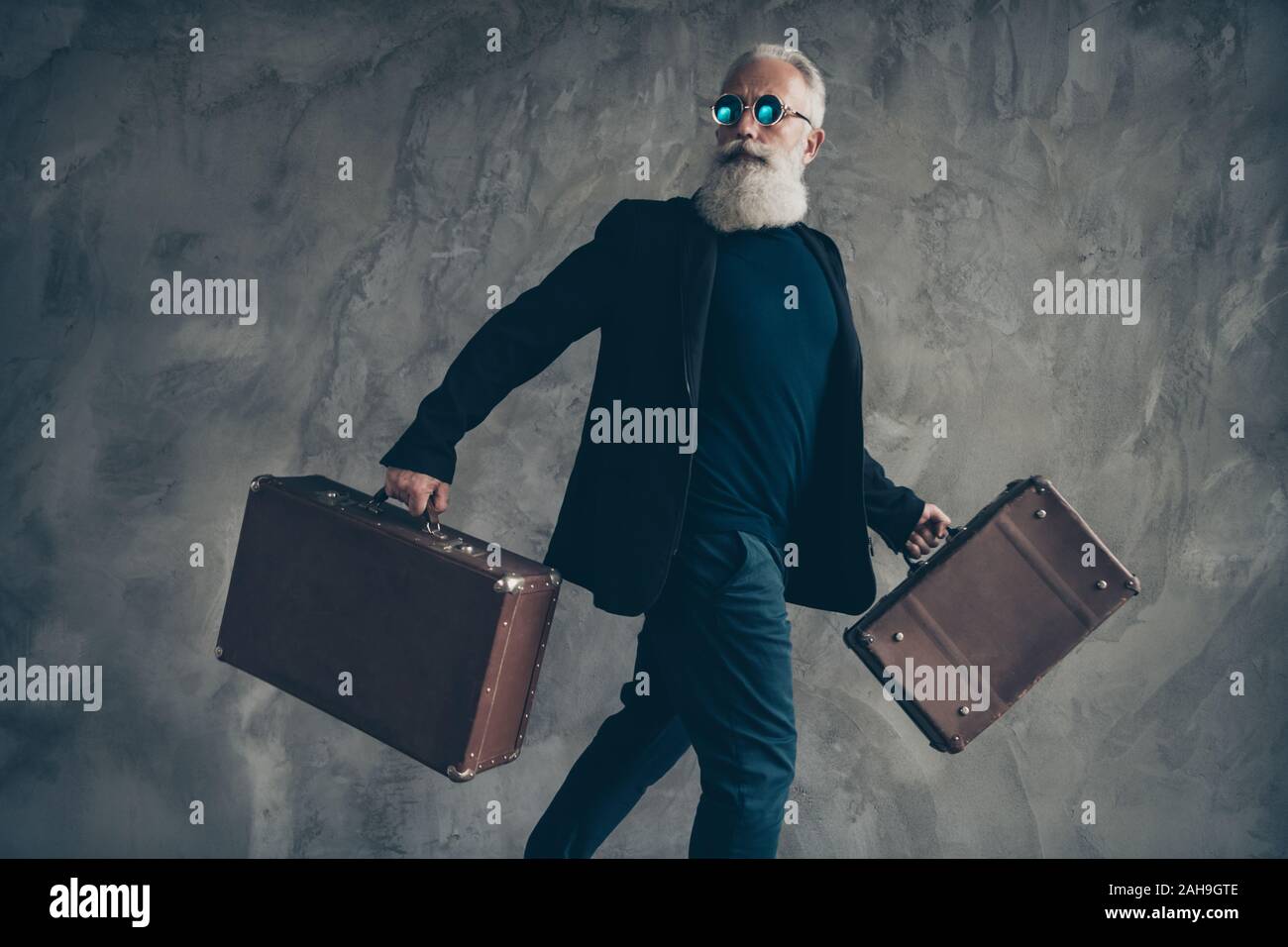 Portrait of cool harsh masculine man in eyewear eyeglasses carry old ...