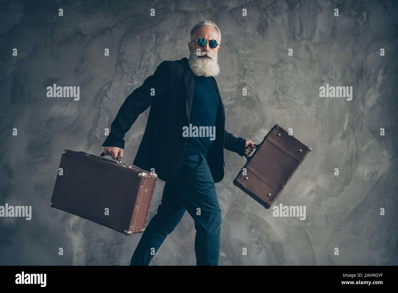 Portrait of harsh masculine man in eyewear eyeglasses holding brown ...