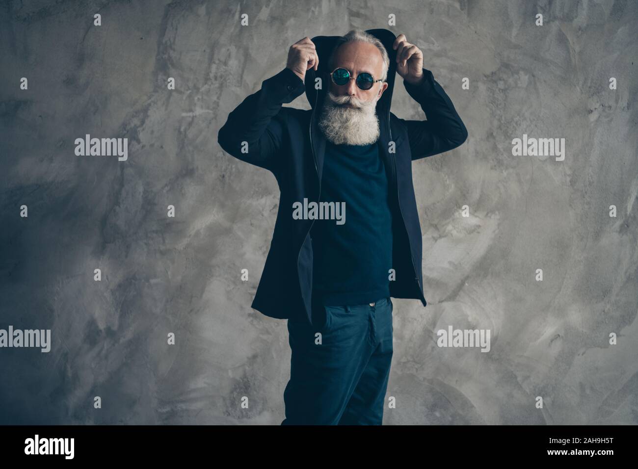 Portrait of attractive harsh masculine man in hood looking wearing ...