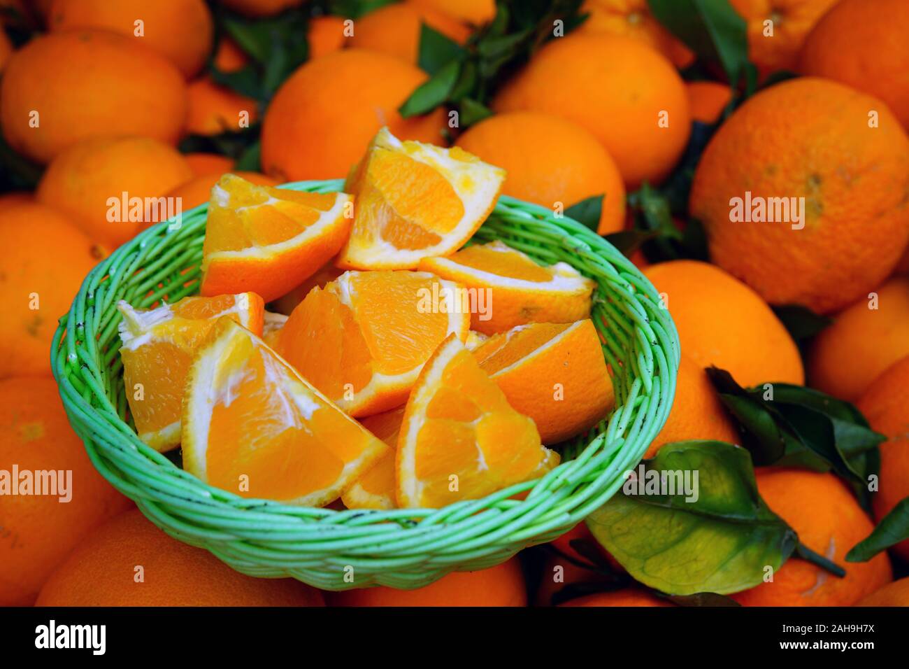 Fresh oranges cut in segments at a produce market Stock Photo - Alamy