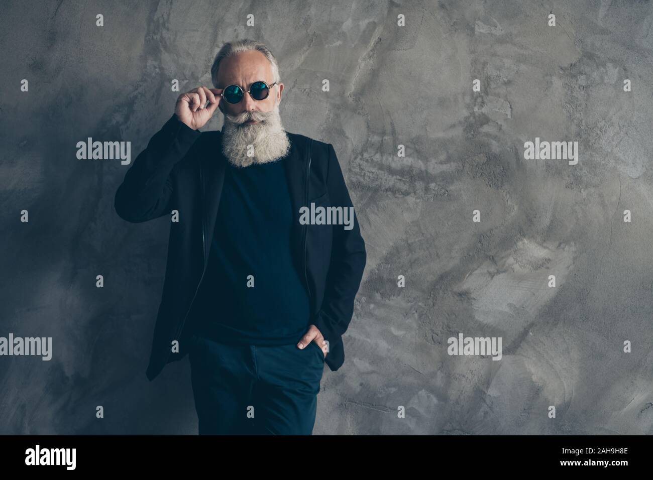 Portrait intelligent harsh masculine gentleman touching his specs ...