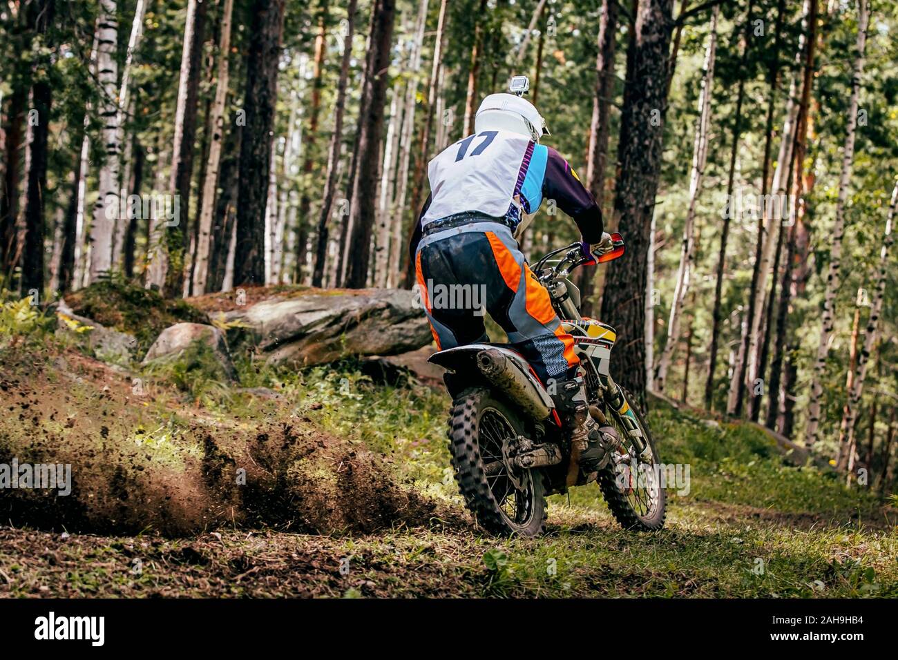motocross rider riding forest trail. spray of dirt rear wheel Stock ...
