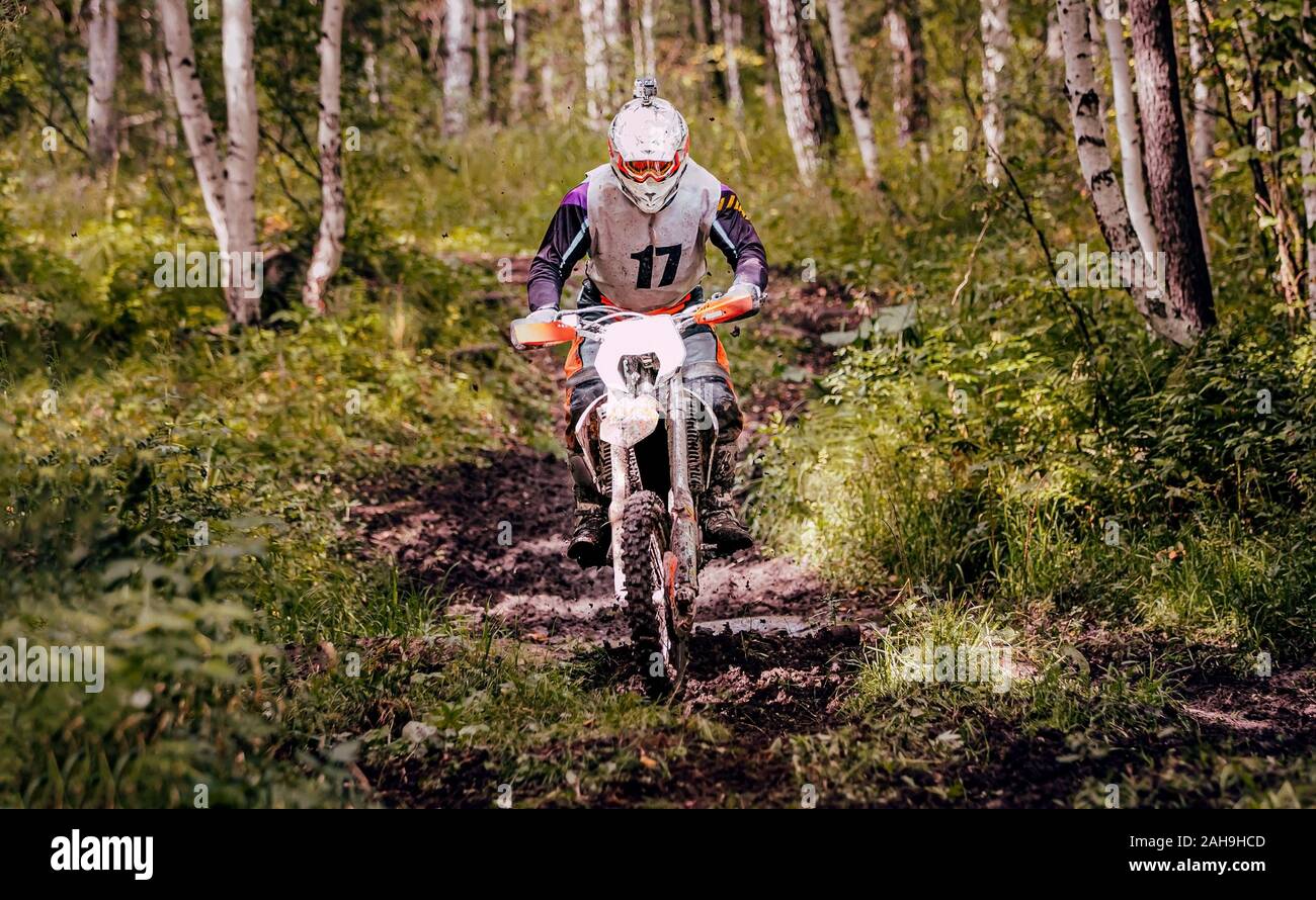 motocross enduro rider riding on muddy forest trail Stock Photo - Alamy