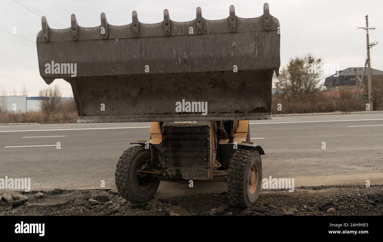 Backhoe loader working on the road Stock Photo - Alamy