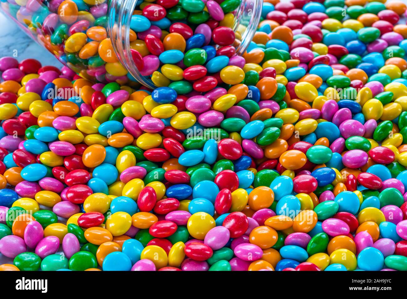 Colorful candy spilling out of a jar - background and texture Stock ...
