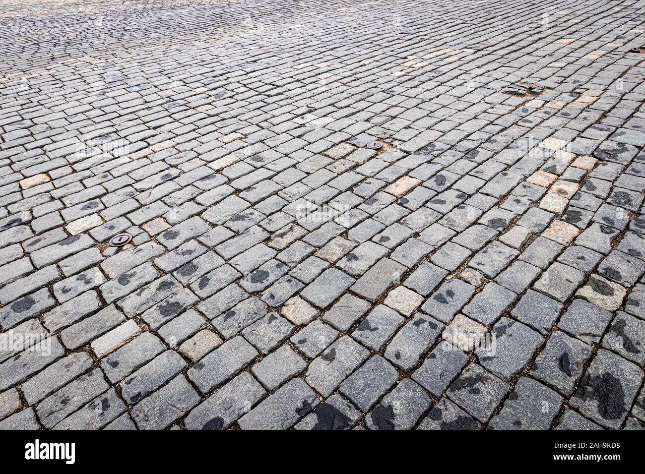 Top view on paving wet stone road after rain. Old pavement of granite ...