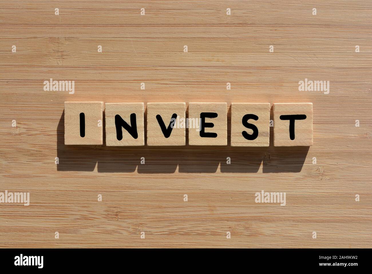 Invest in 3d wooden alphabet letters on a bamboo wood background Stock ...